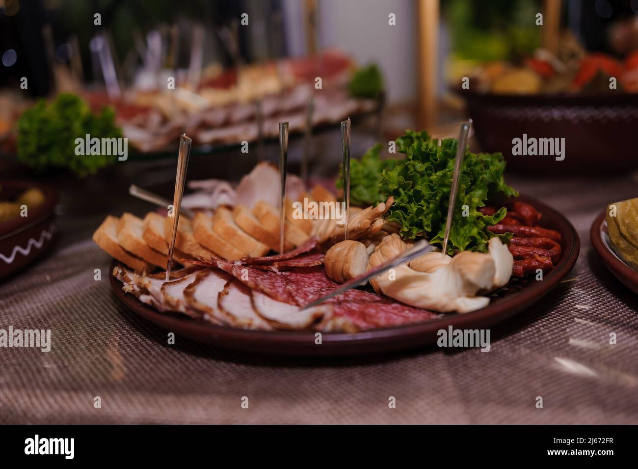 Slicing different varieties of meat. Wedding buffet Stock Photo - Alamy