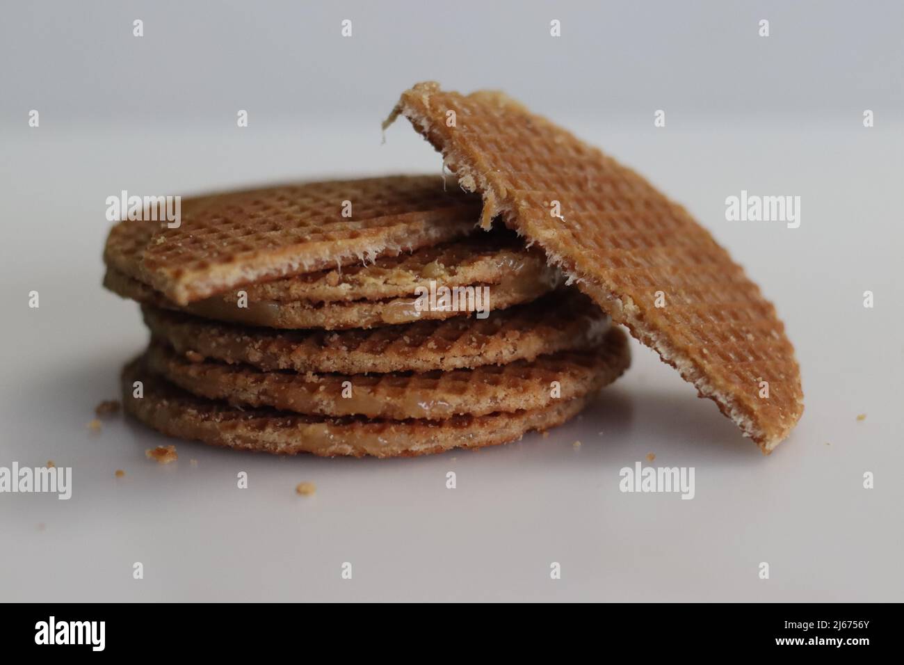 Stoopwafles. A stack of popular jumbo syrup waffels with honey. Shot on ...