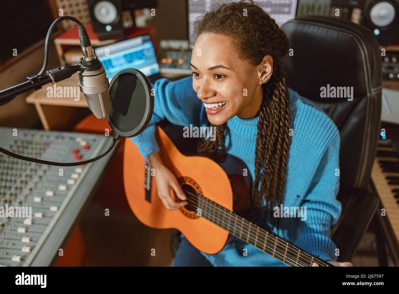 Passionate African American woman singer playing the guitar and ...