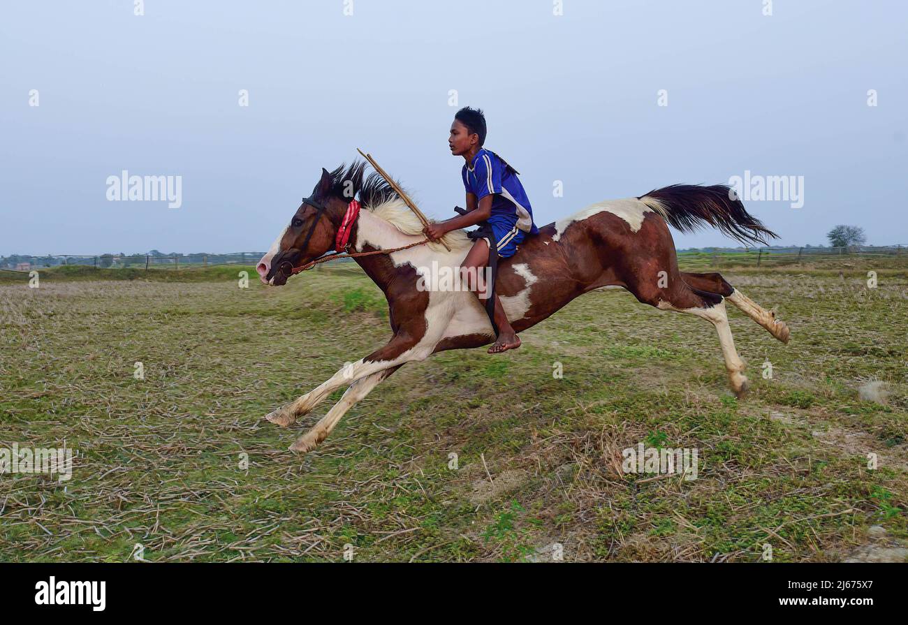 A young Jockey rides a horse during a Rural Horse Race. After the ...