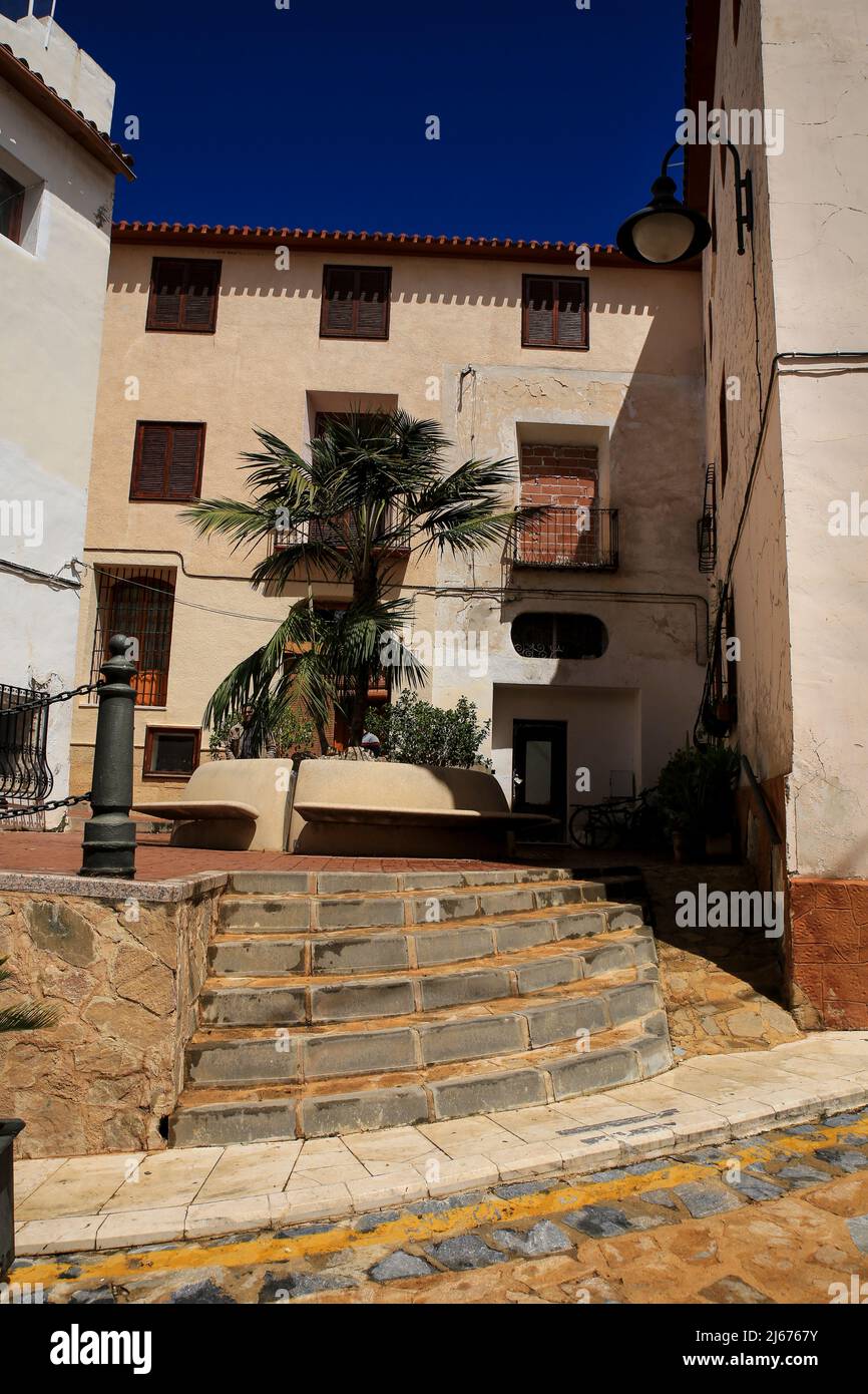 Narrow cobbled street and beautiful facades in Finestrat village ...