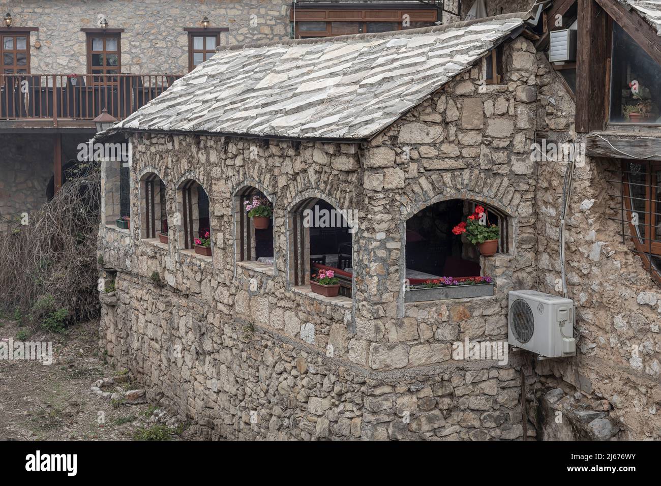 Light coloured stone building with open arched windos and an air ...