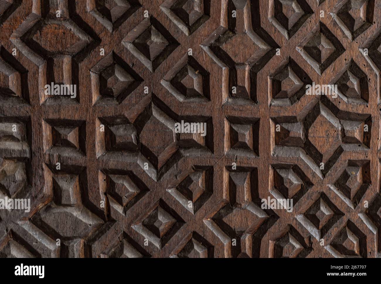 Dark wood old time carved background with outstanding shapes and ...