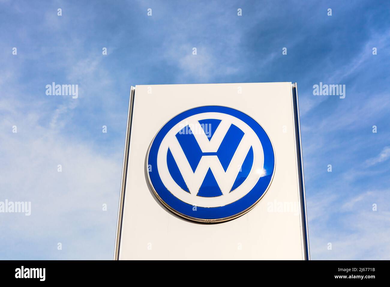 Volkswagen brand logo on bright blue sky background located on its ...