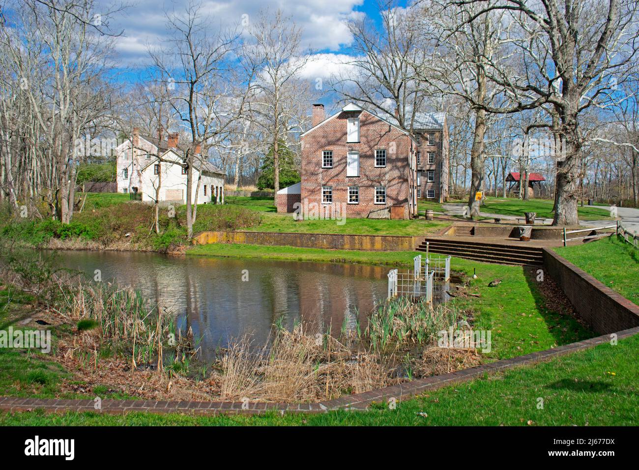 Blue skies with white clouds reflected in a small pond at Allaire State ...