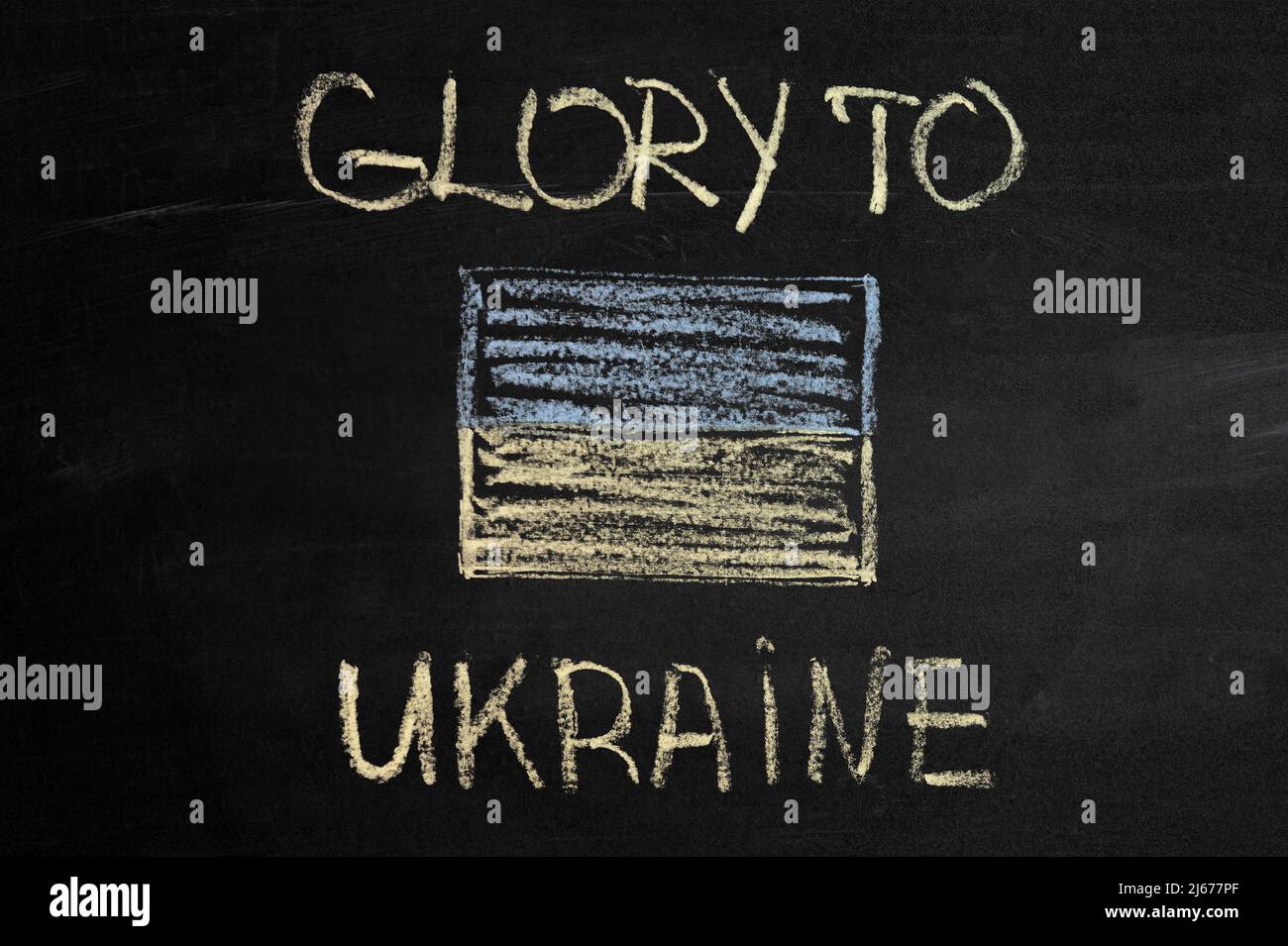 inscription glory to Ukraine on a black board with chalk. ukraine flag ...