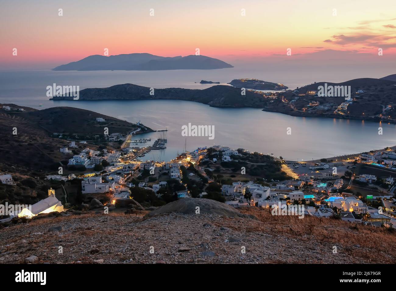 Colorful sunset and view of the illuminated harbor of Ios and the ...