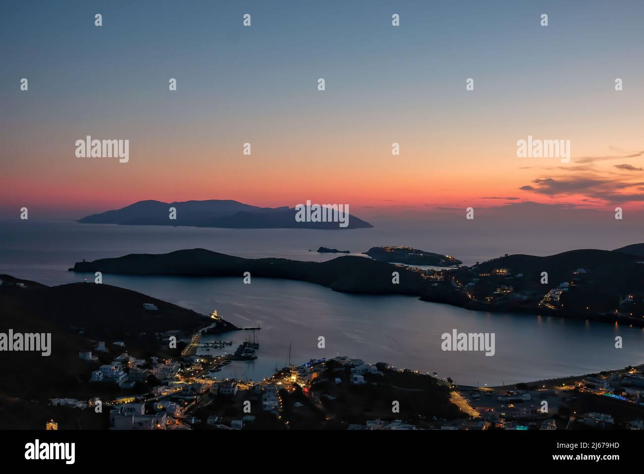Colorful sunset and view of the illuminated harbor of Ios and the ...