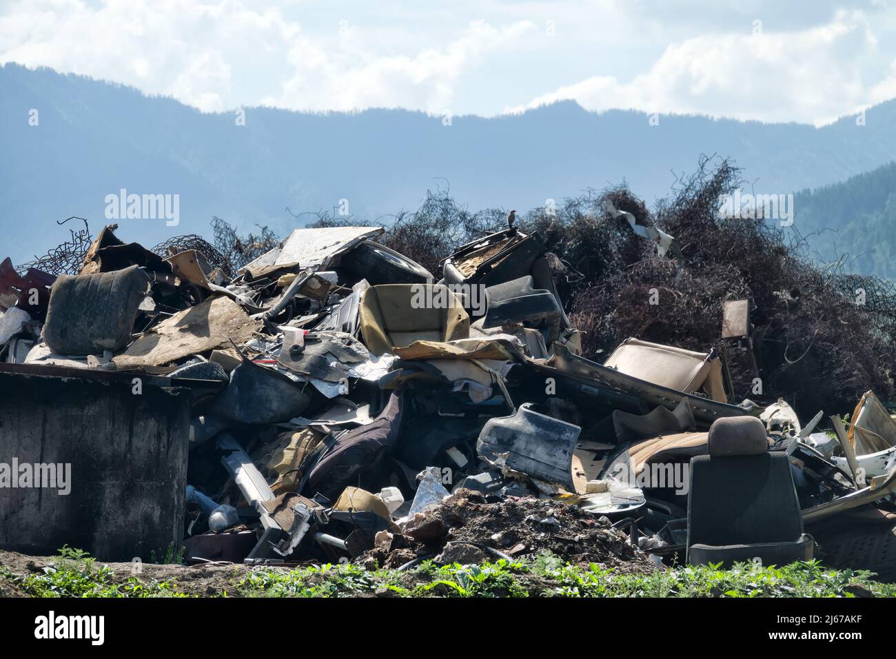 A mountain of scrap metal in the mountains. Pollution of nature by ...