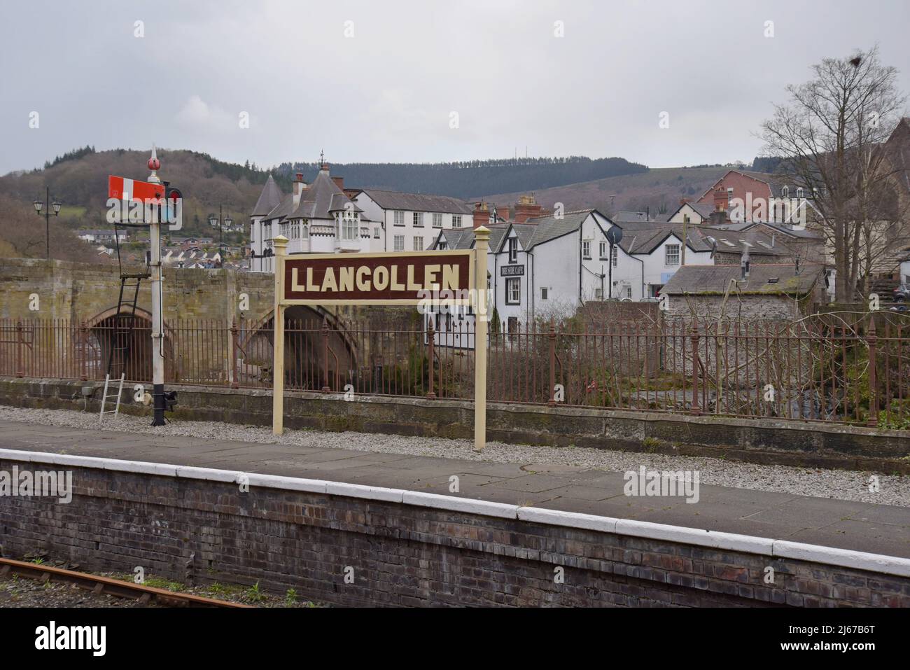 A view of the platform, signal and station nameboard at Llangollen ...