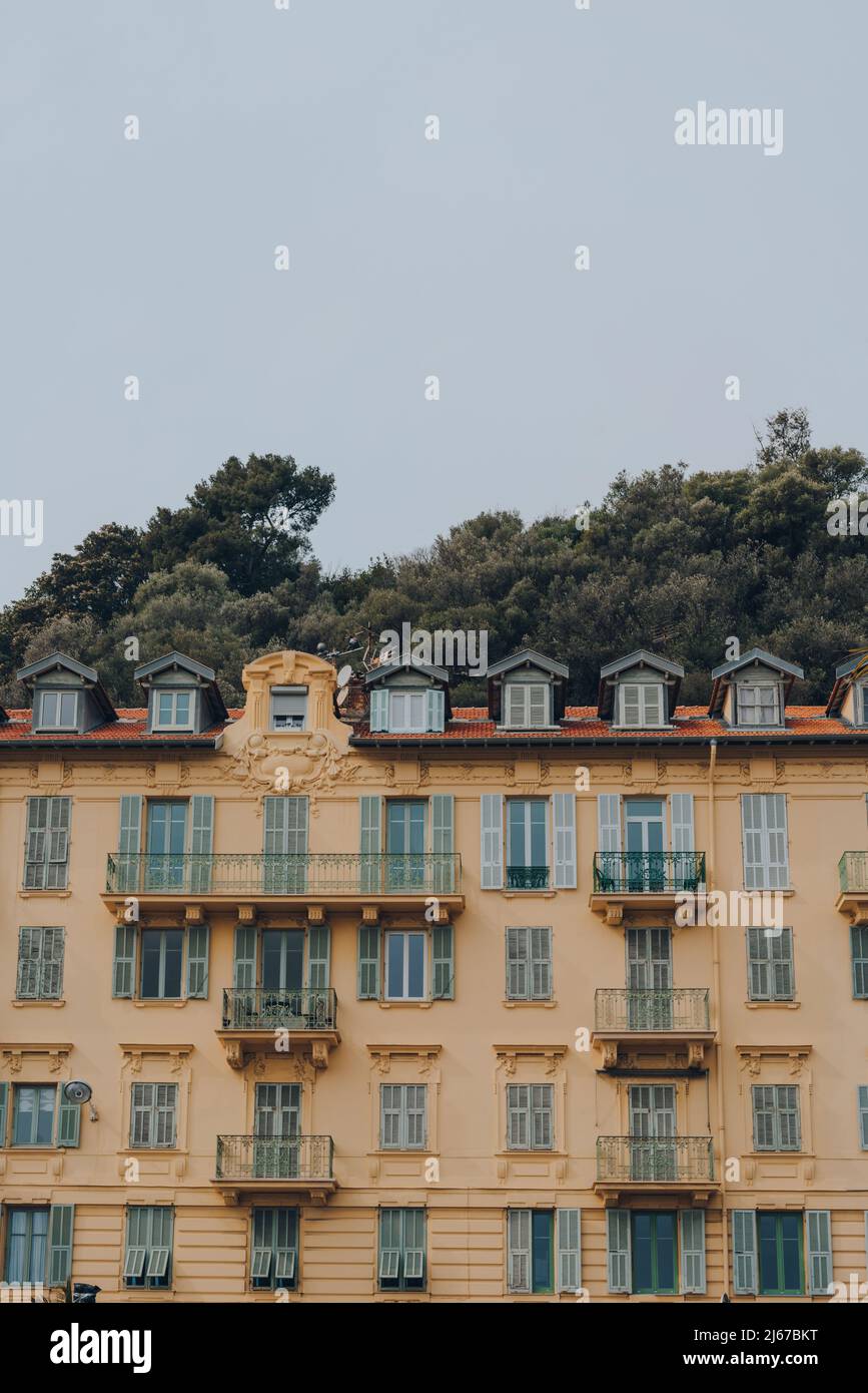 Traditional colourful apartment block building with balconies in Nice ...