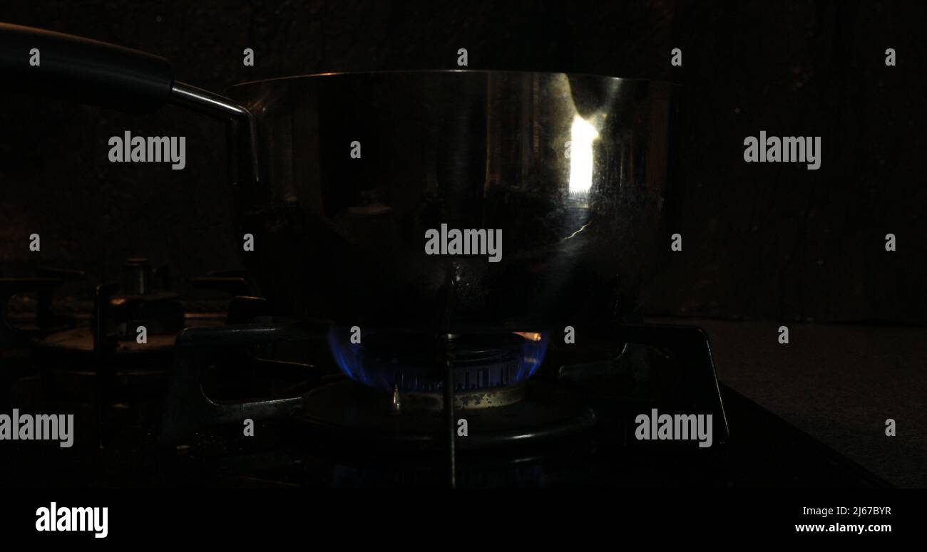 Ignition of the heat under the pot in the kitchen Stock Photo - Alamy