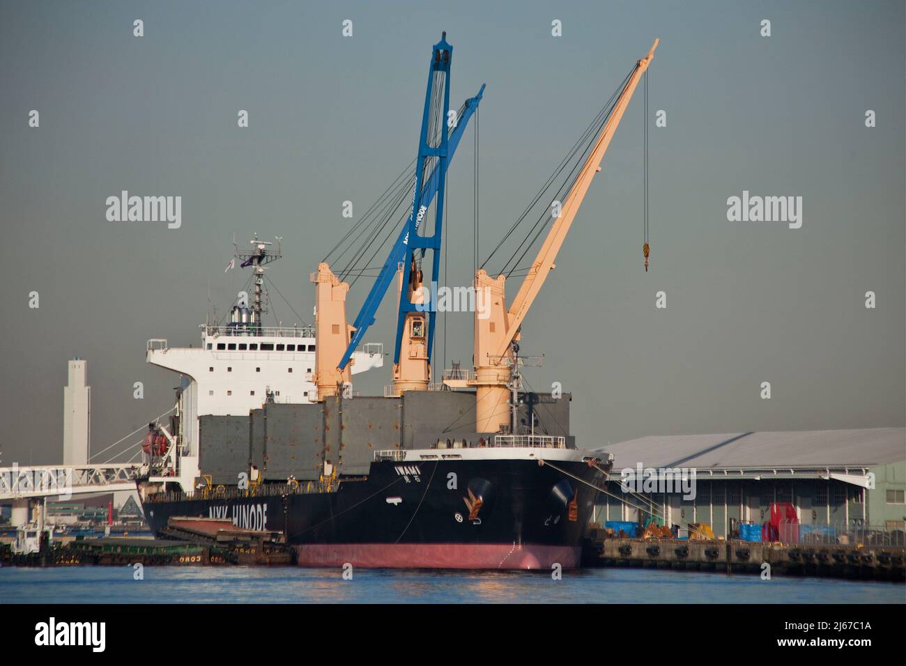 Cargo ship loading at port in Yokohama Japan Stock Photo - Alamy