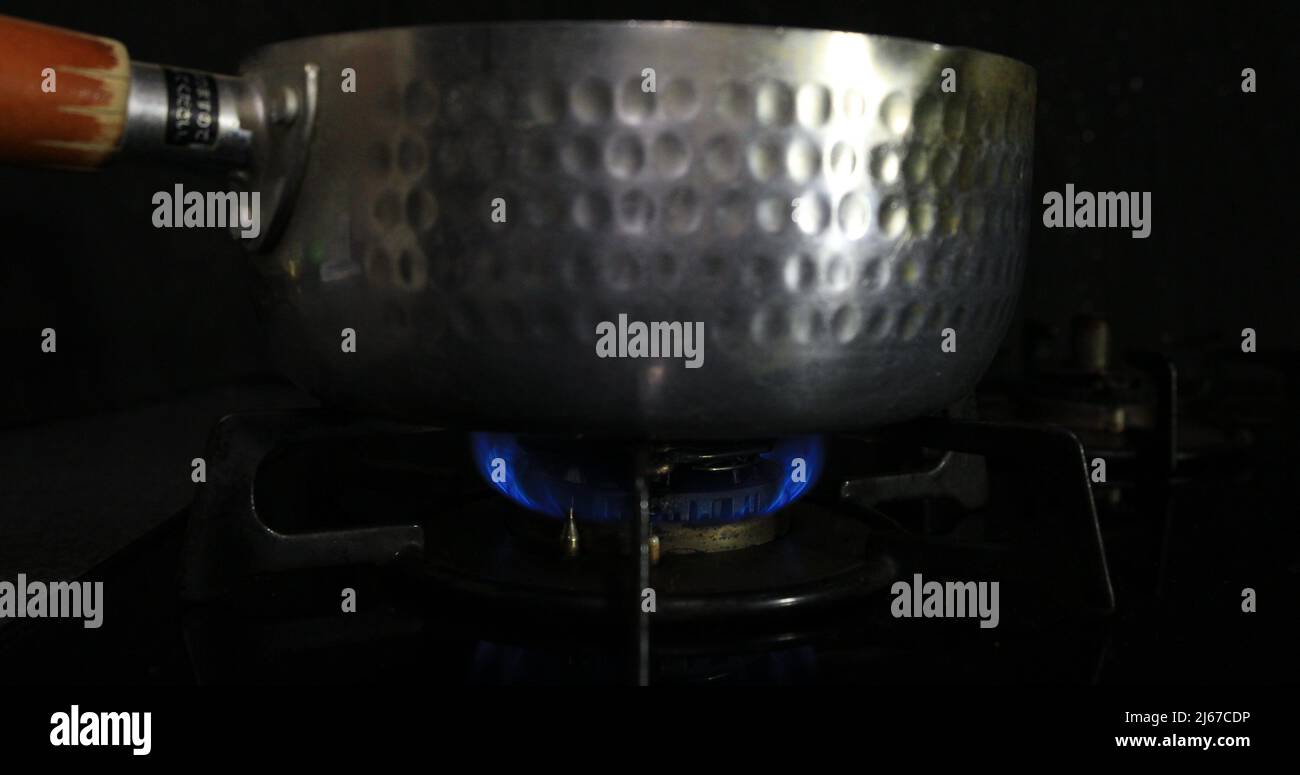 Ignition of the heat under the pot in the kitchen Stock Photo - Alamy