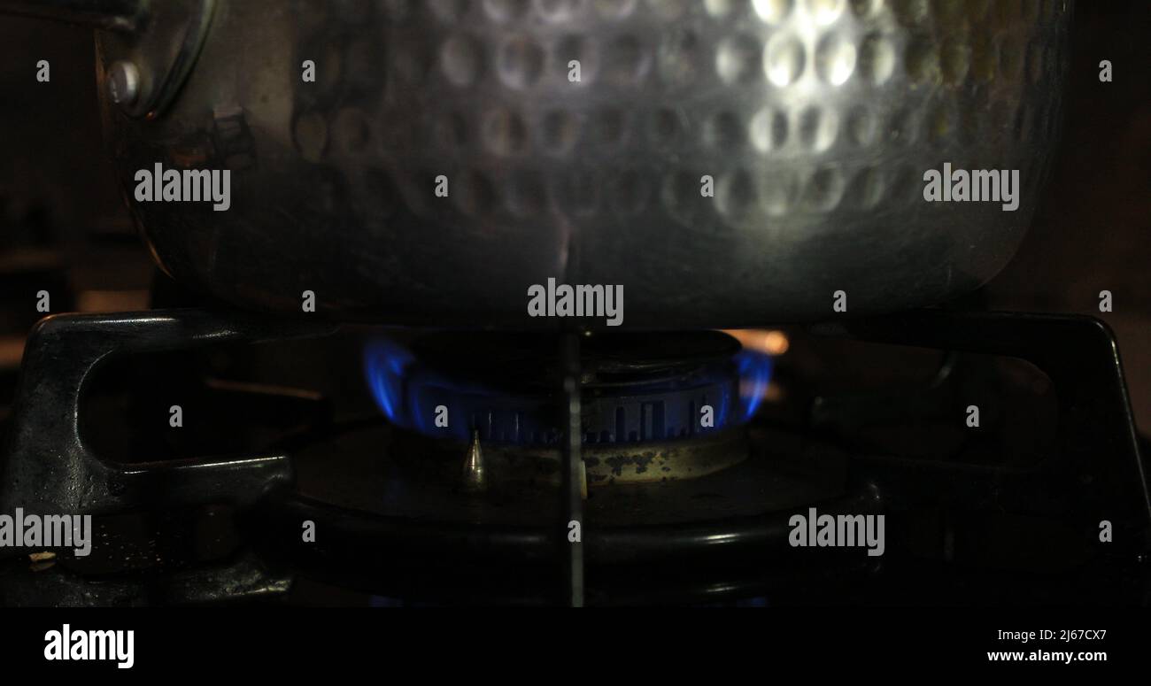 Ignition of the heat under the silver pot in the kitchen Stock Photo ...