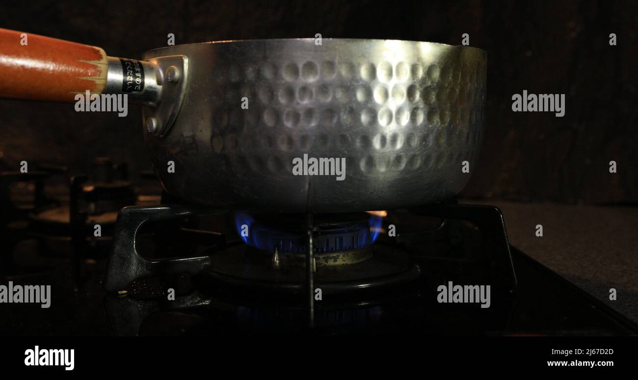 Ignition of the heat under the pot in the kitchen Stock Photo - Alamy