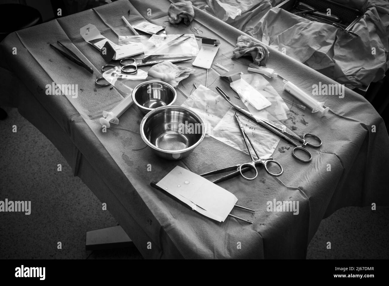 in an operating room there is a used operating table with instruments ...