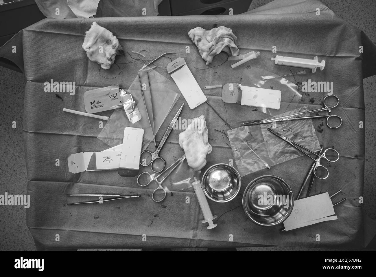 in an operating room there is a used operating table with instruments ...