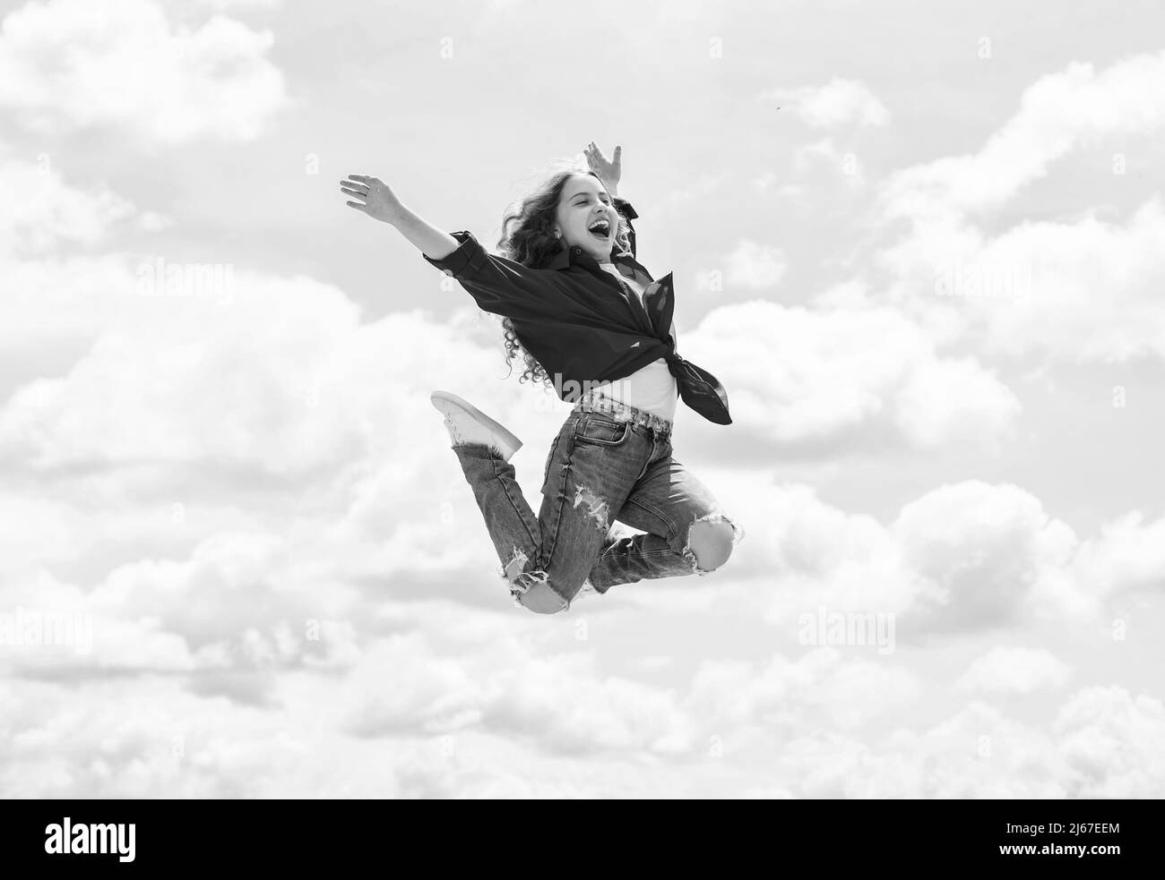 smiling child jumping so high. carefree and joyful. kid fashion style ...