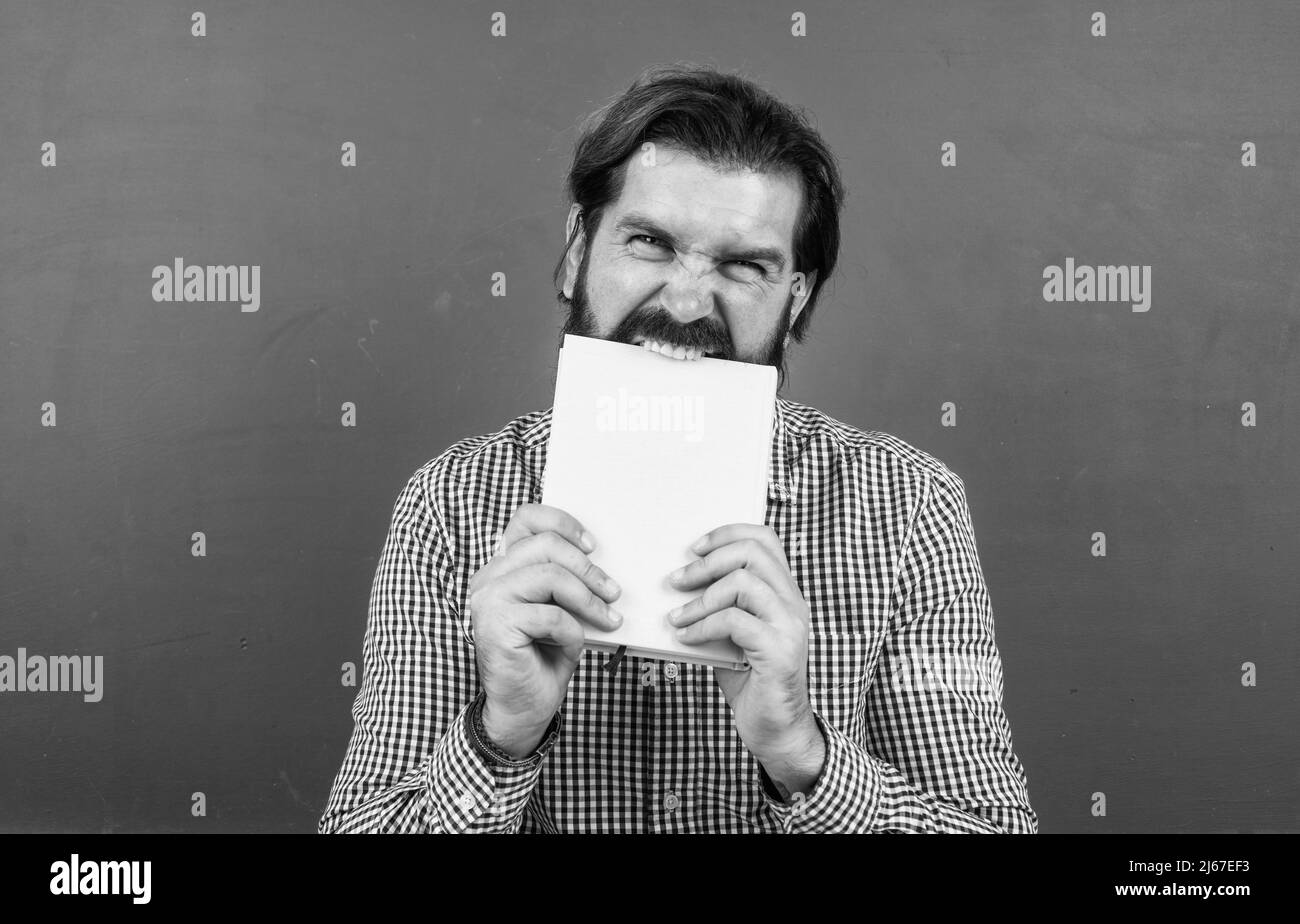 angry mature college man biting book, stress Stock Photo - Alamy