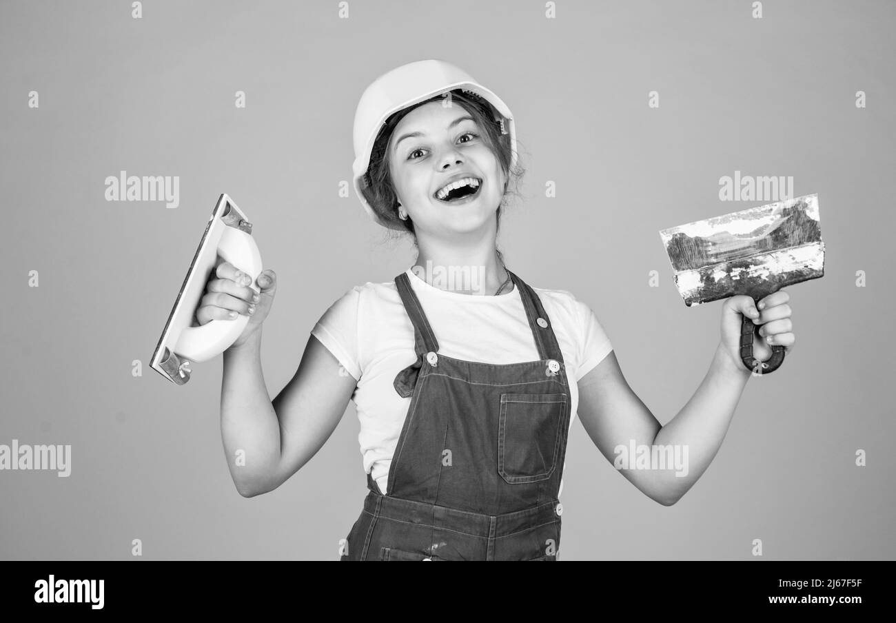 kid with helmet holding spatula. kid bricklayer masonry worker with ...