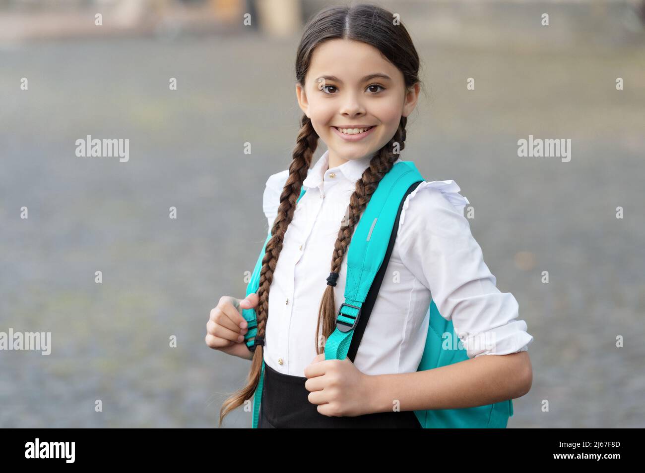 happy braided girl with backpack in school uniform Stock Photo - Alamy