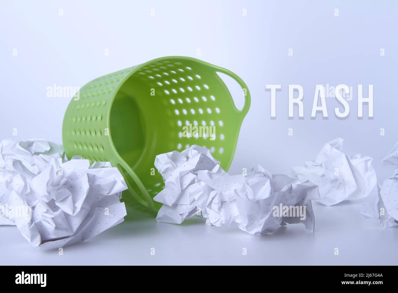 Green trash can. Full basket. Crumpled paper in a basket. A mountain of ...