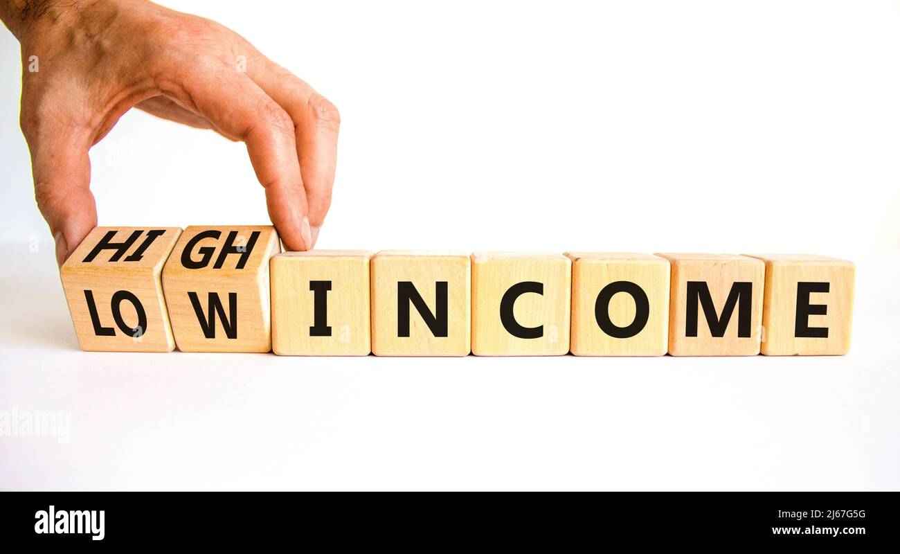 Low or high income symbol. Businessman turns wooden cubes and changes ...