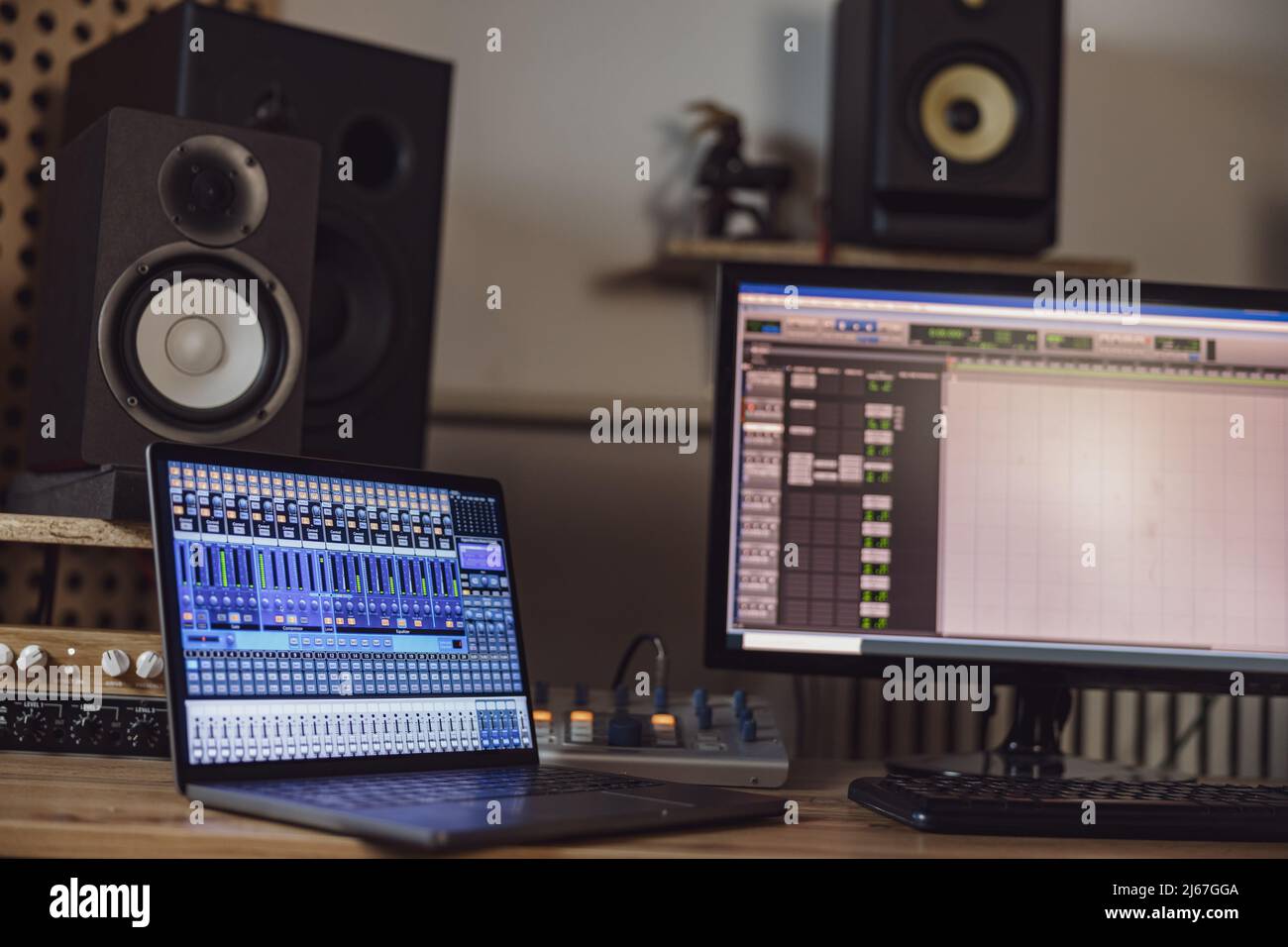 Close-up of switched on laptop and monitor screen on table in ...