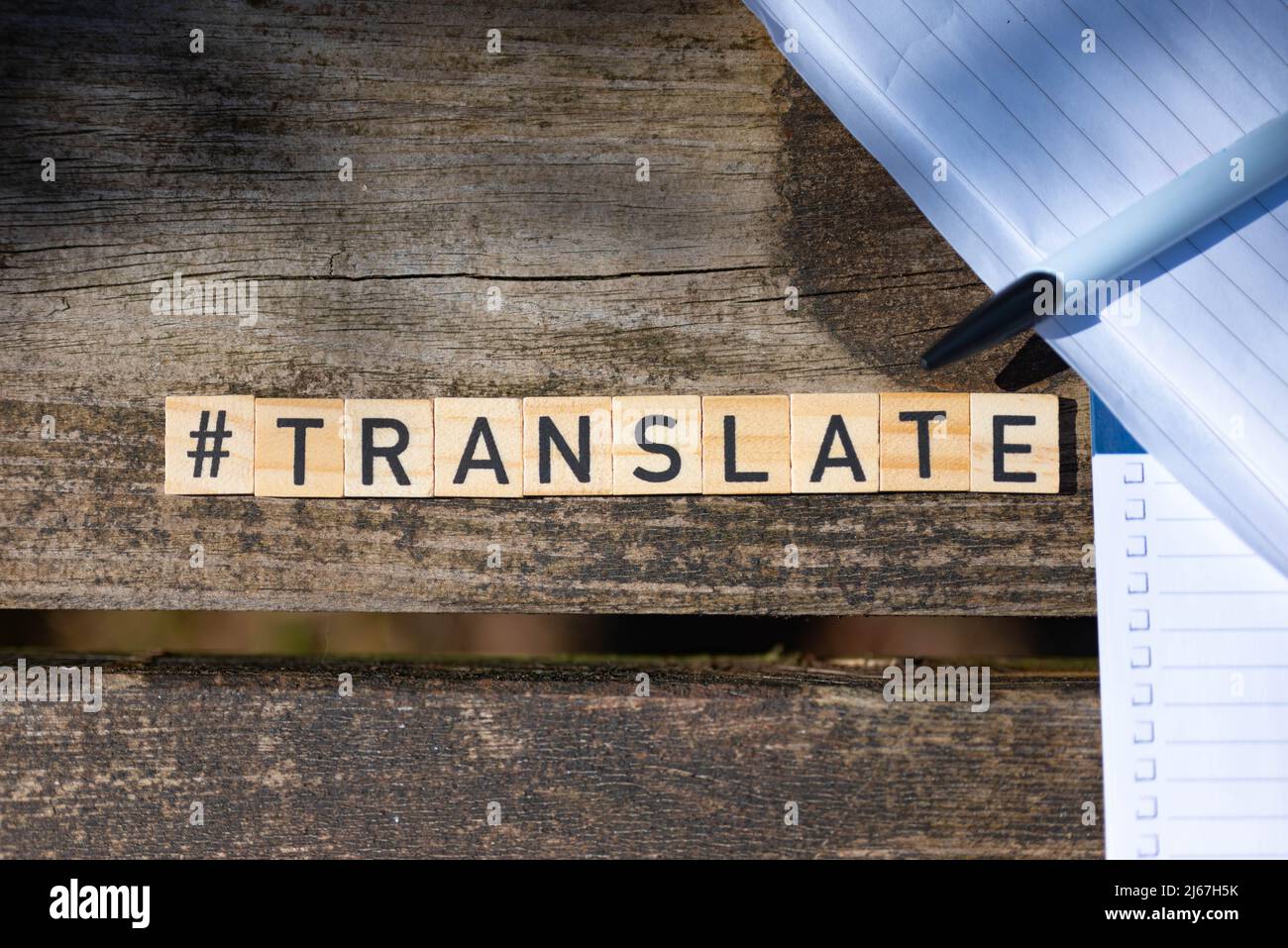 Wooden toy blocks with the text translate with pen and paper in the ...