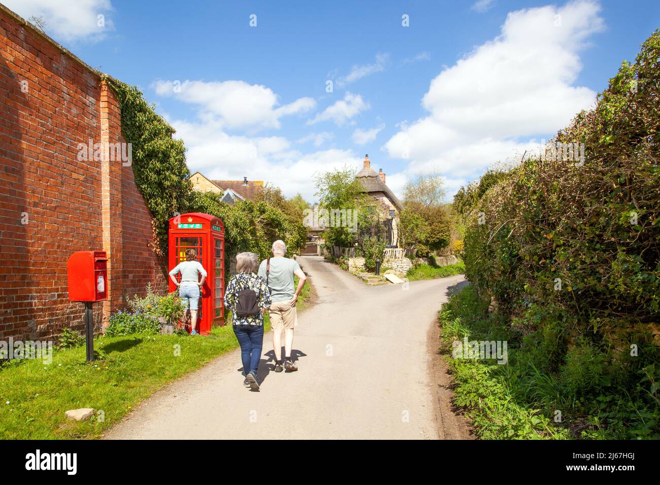 People walking through the hamlet of Grafton sitting below the Bredon ...