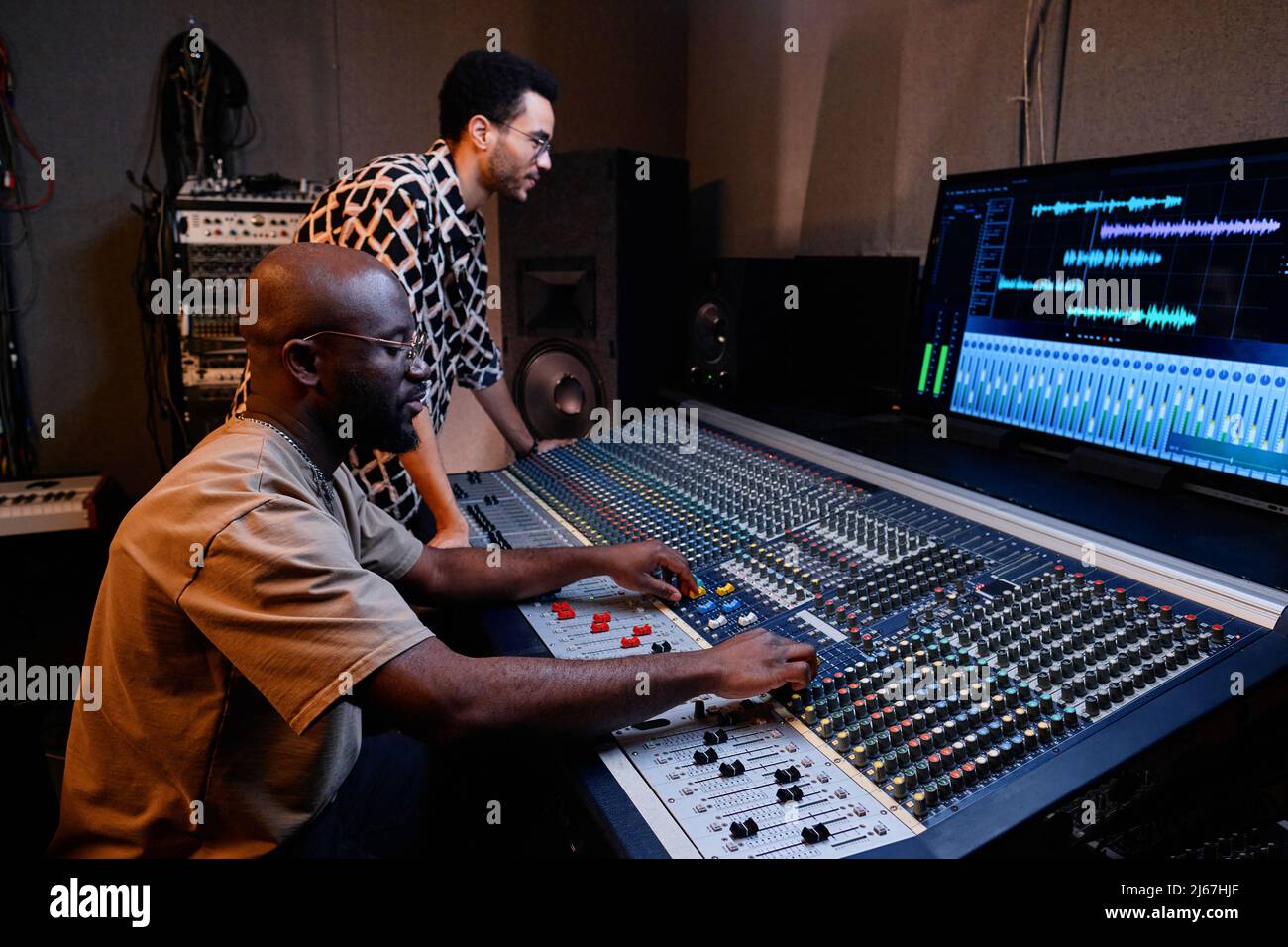Professional mature African American producer and young musician ...