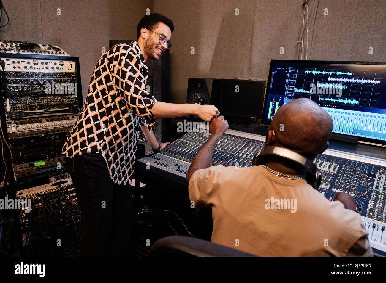 Successful African American music producer and young singer finishing ...