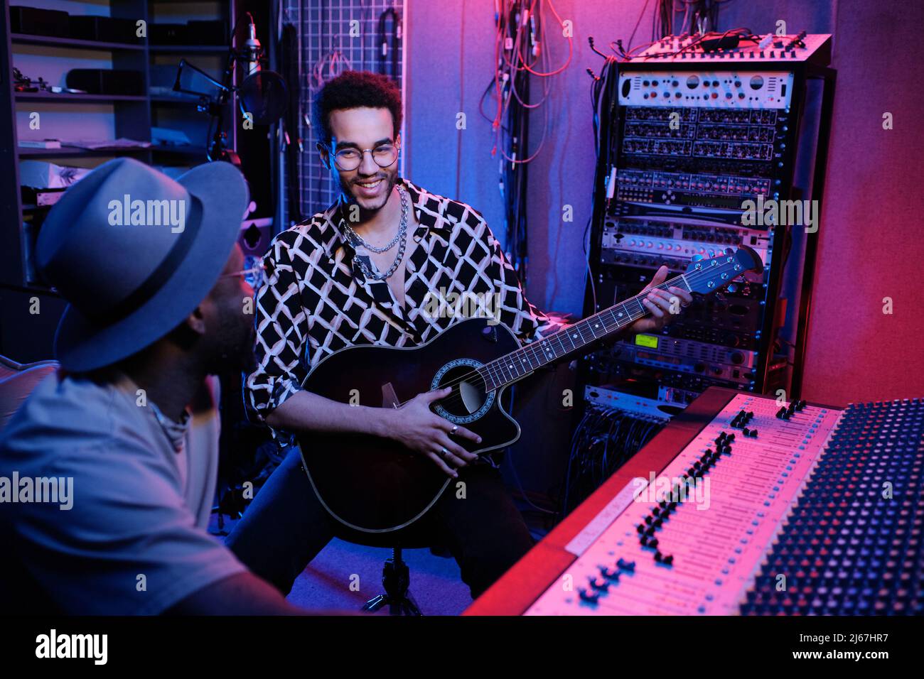 Professional producer and young African American guitar player having ...