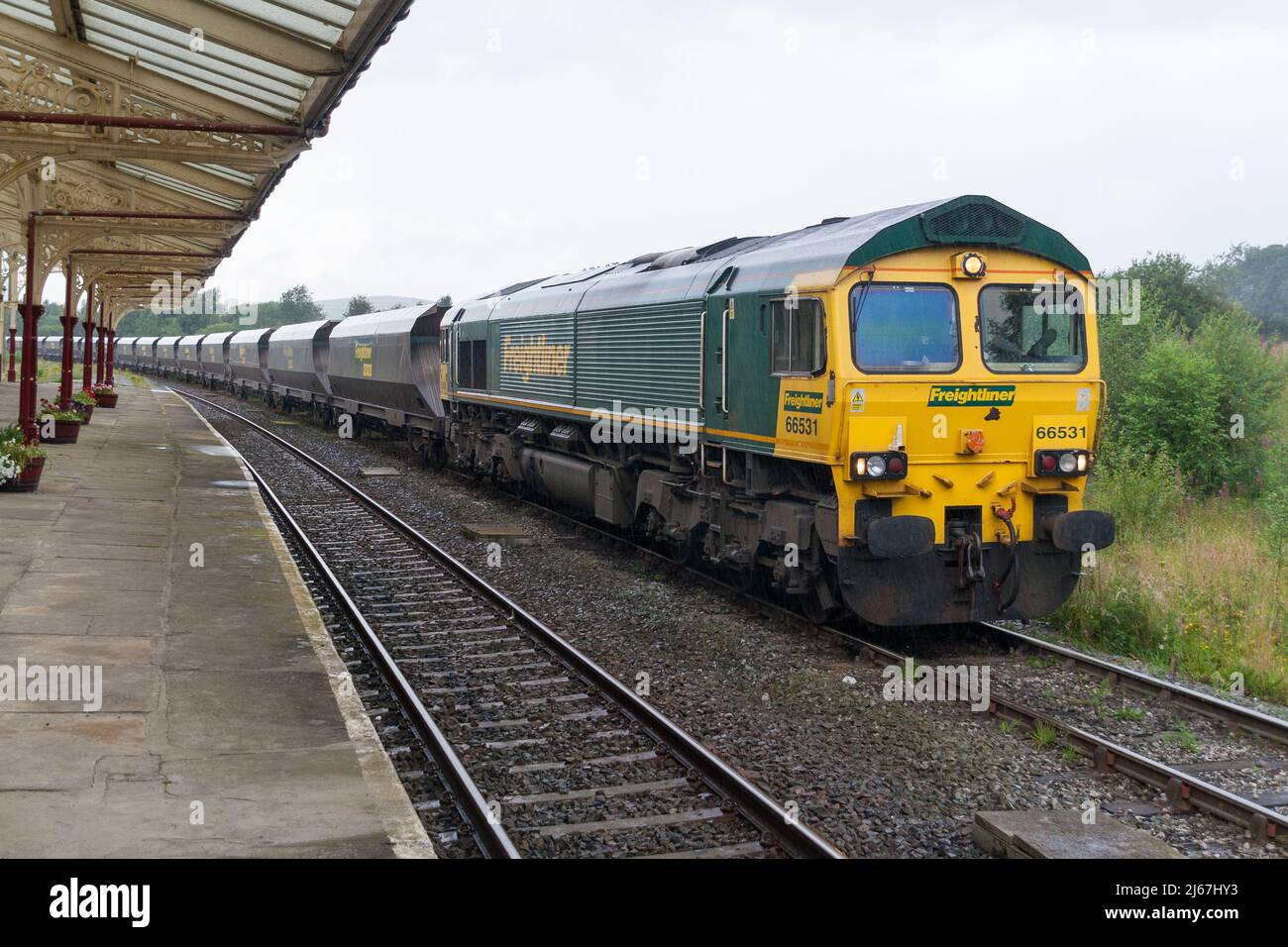 A freight train pulled by a class 66 diesel locomotive at Hellifield ...
