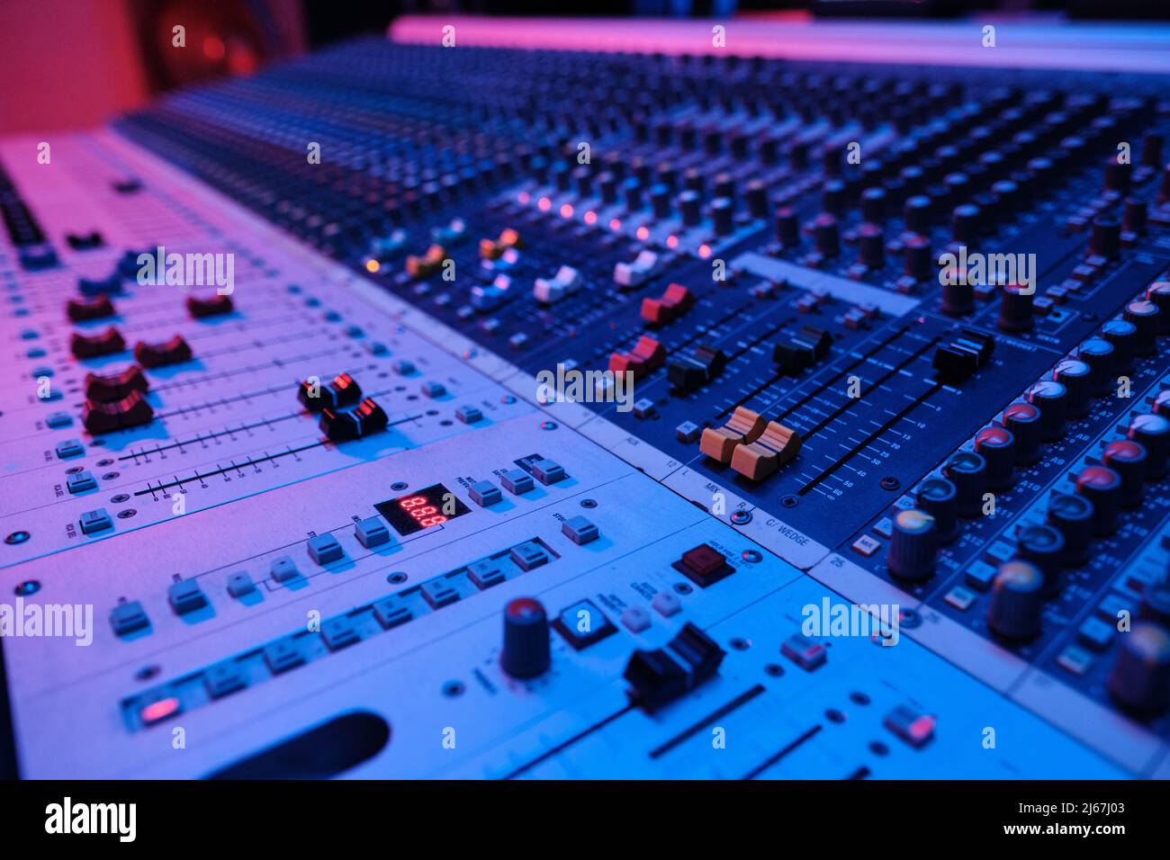 Horizontal no people shot of modern mixing console surface in recording ...