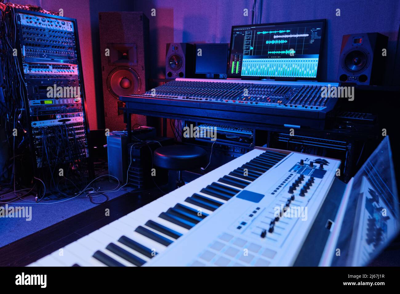 Horizontal no people shot of recording studio room interior with mixing ...