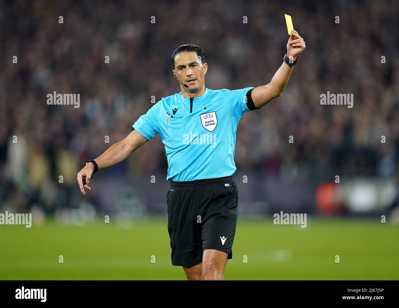 Referee Serdar Gozubuyuk shows a yellow card to during the UEFA Europa ...