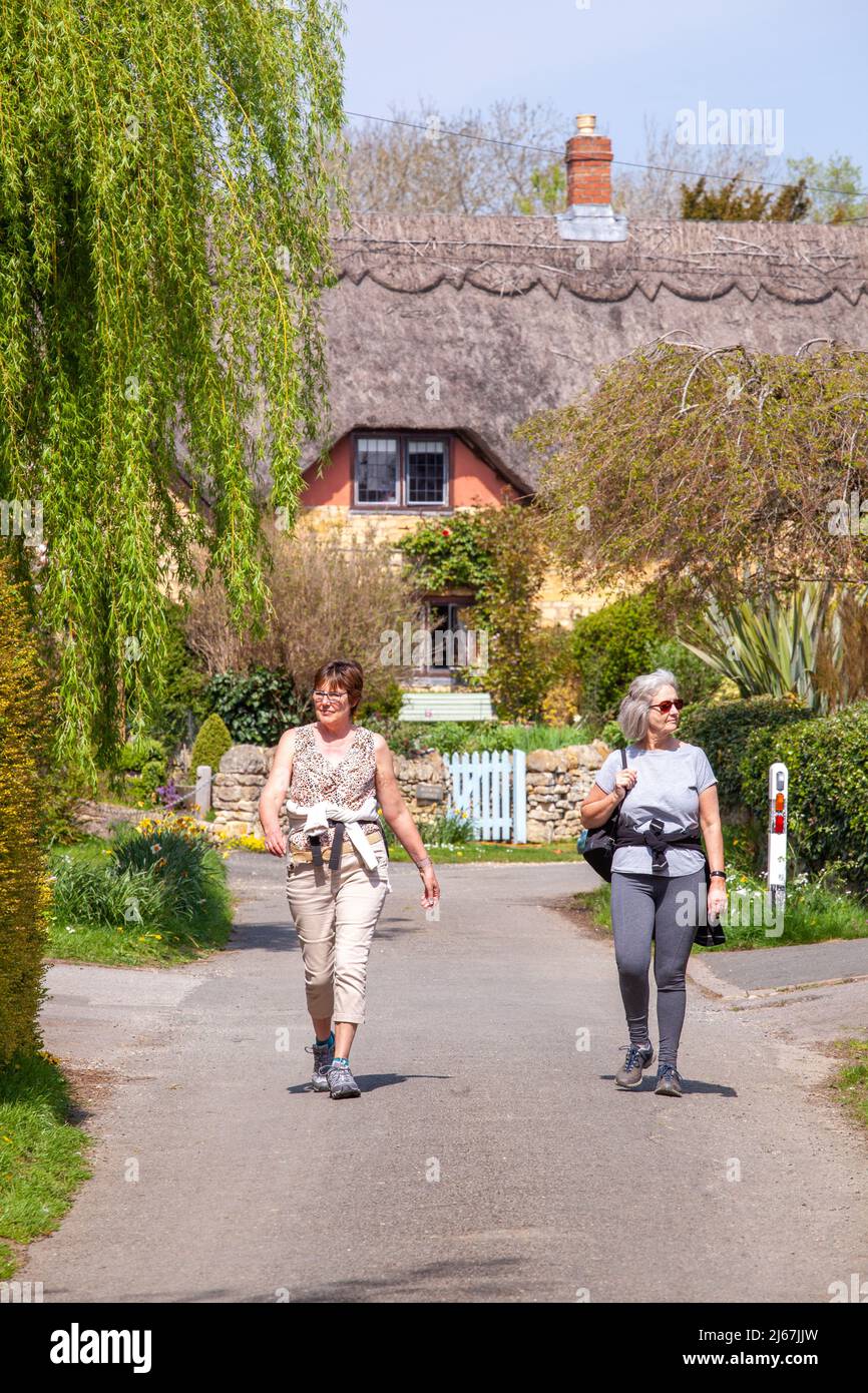 Two women walking through the village of Kemerton a civil parish in ...
