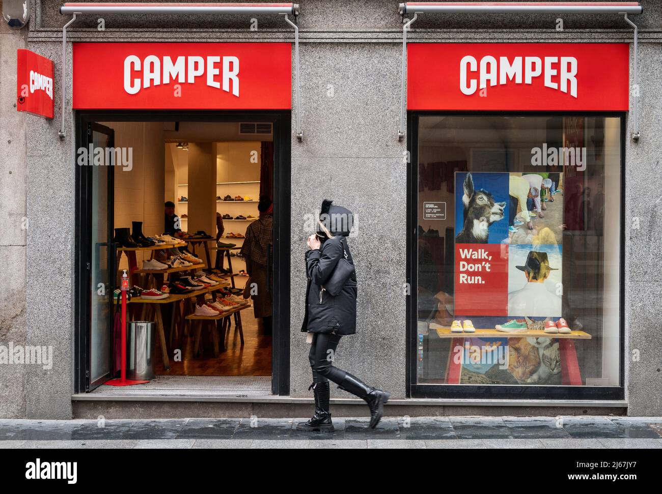 A pedestrian walks past the Spanish multinational manufacturing and ...