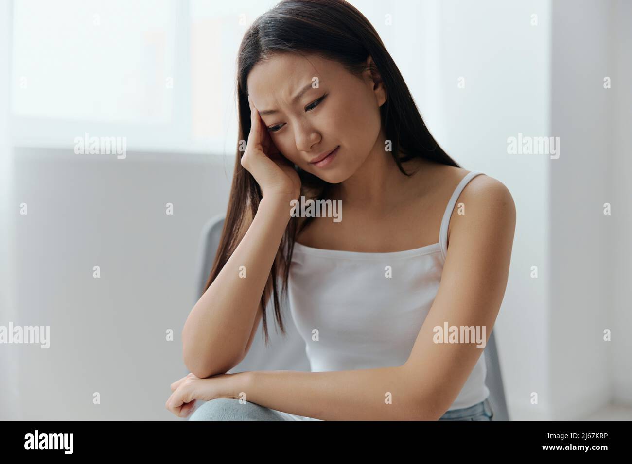 Panic attack. Upset tormented tanned beautiful young Asian woman ...