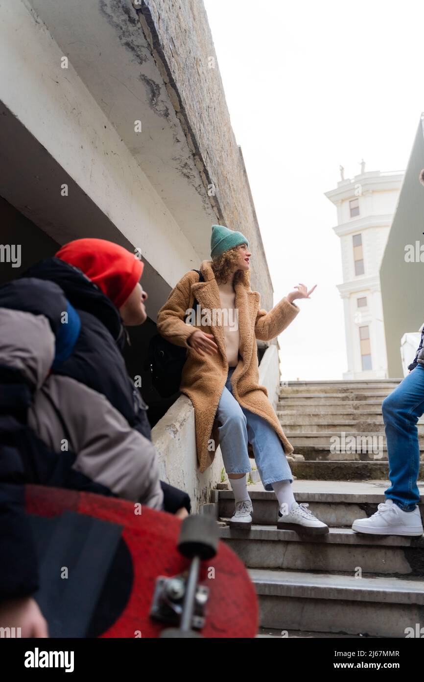 Group of amazing and attractive friends are laughing and talking about ...