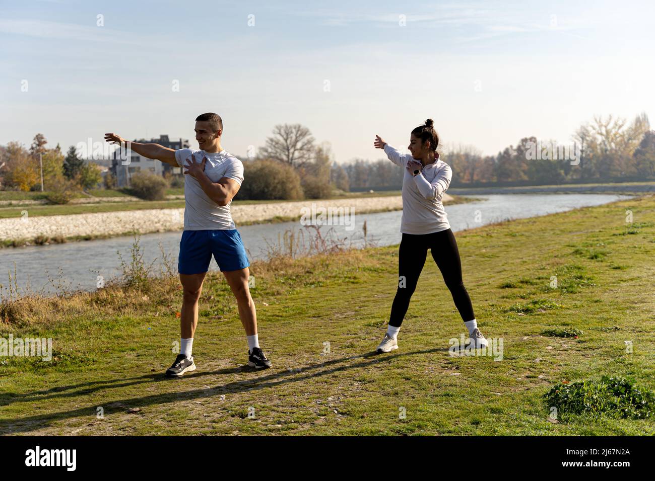 Two amazing and attractive fit friends are warming up together Stock ...