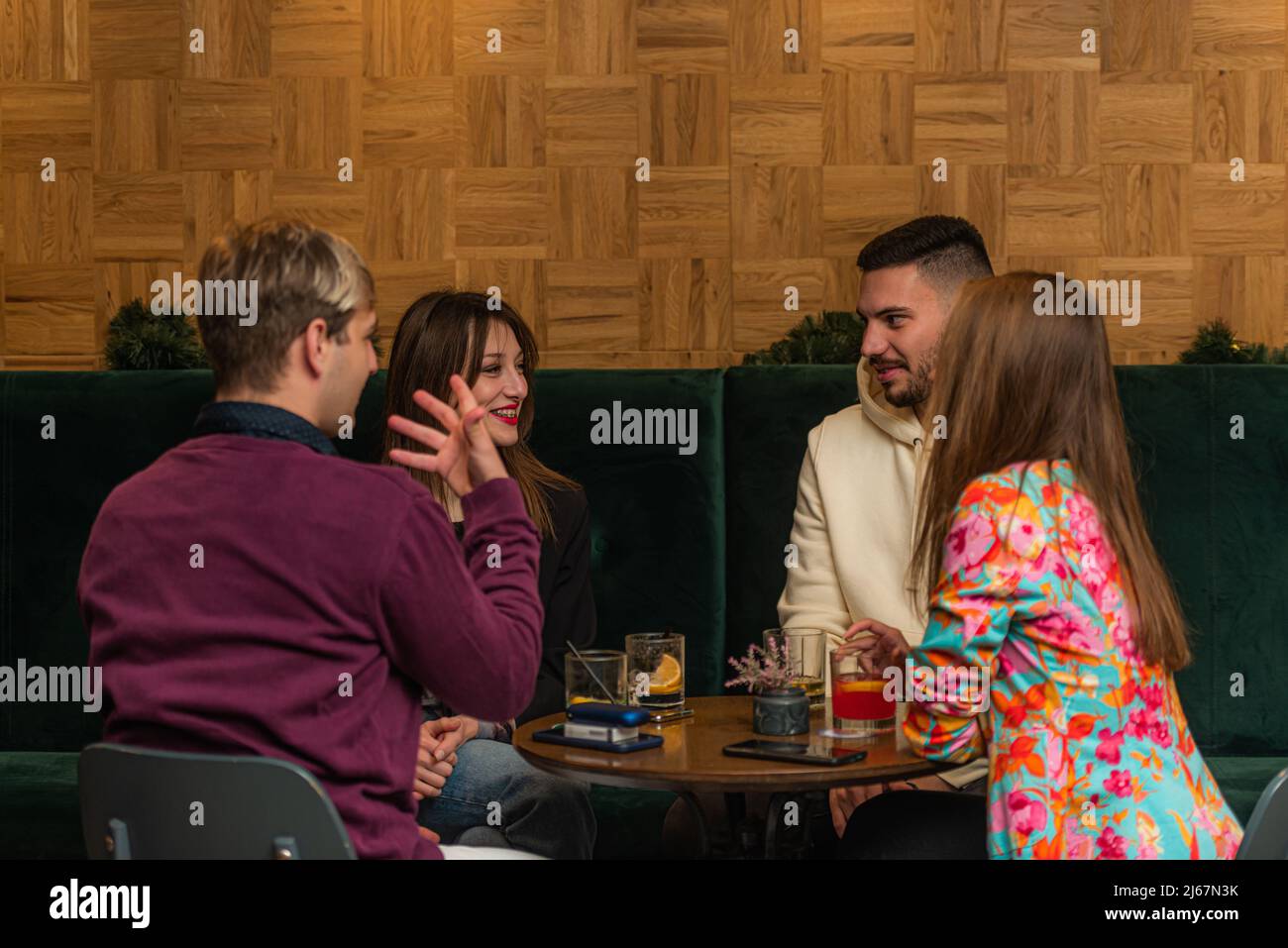 Two amazing and attractive couples are having a fun conversation Stock ...