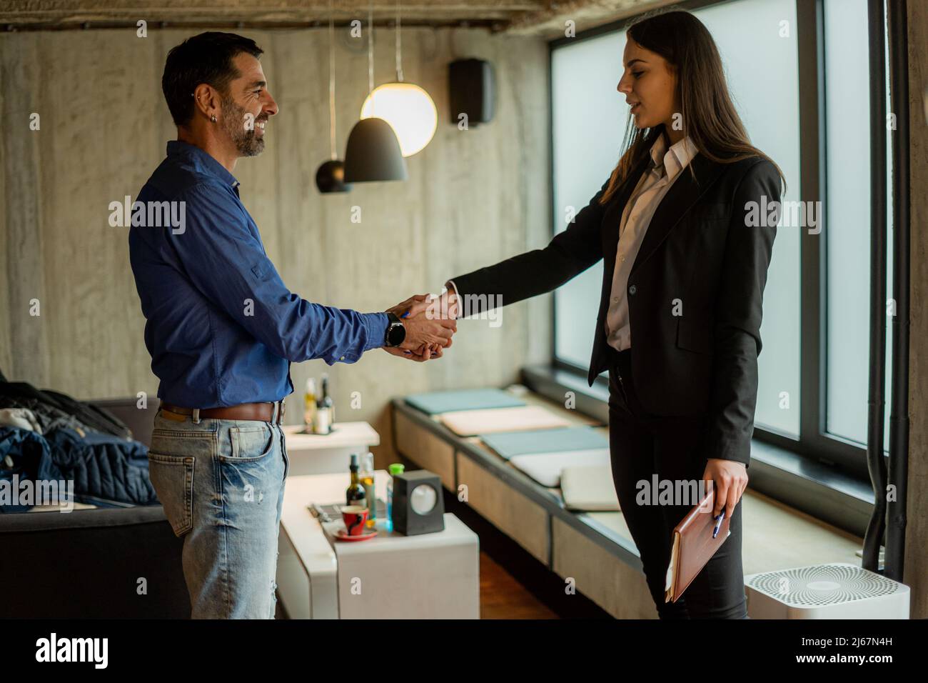 Two amazing and beautiful business people are making a deal with a ...