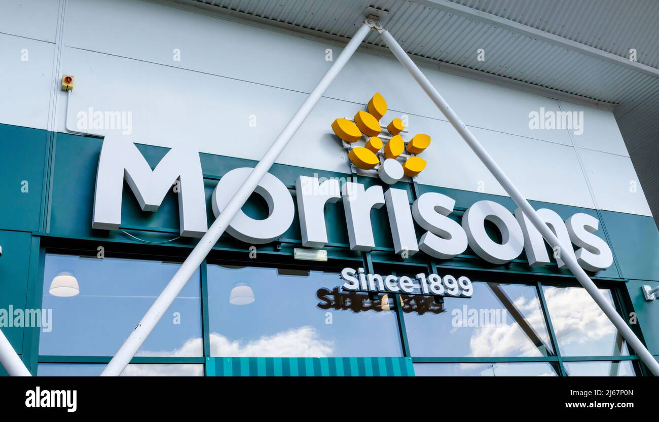Morrisons name and logo above the entrance to its supermarket in Woking ...