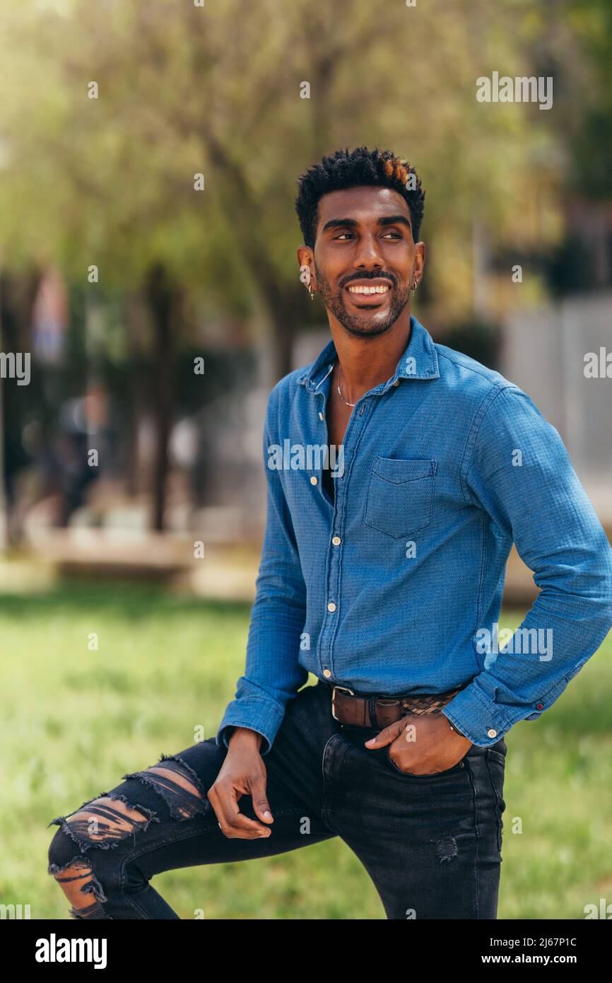 vertical portrait of young latin man smiling Stock Photo - Alamy