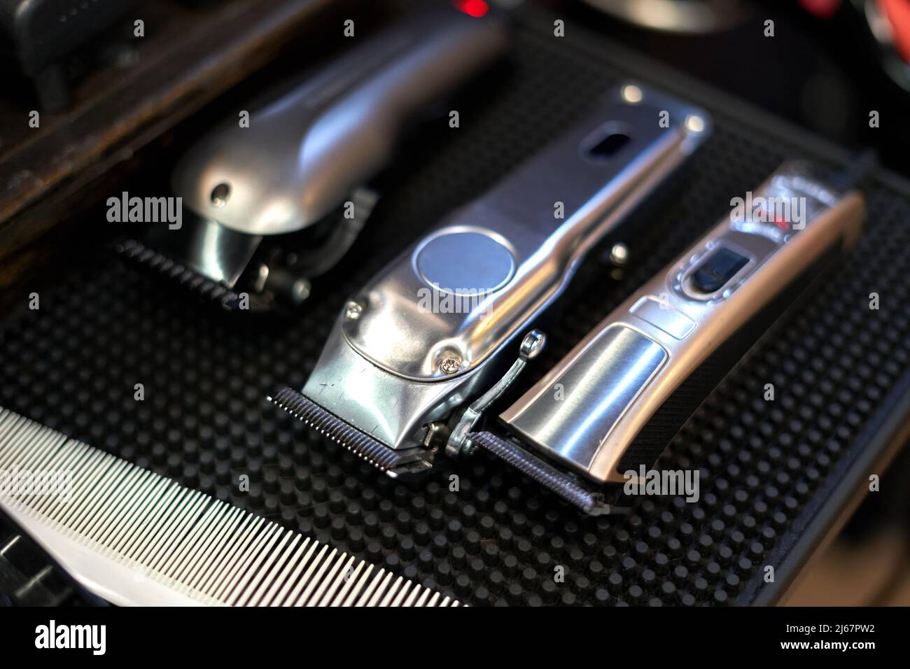 Three hair clippers on a rubber surface in a barber shop Stock Photo ...
