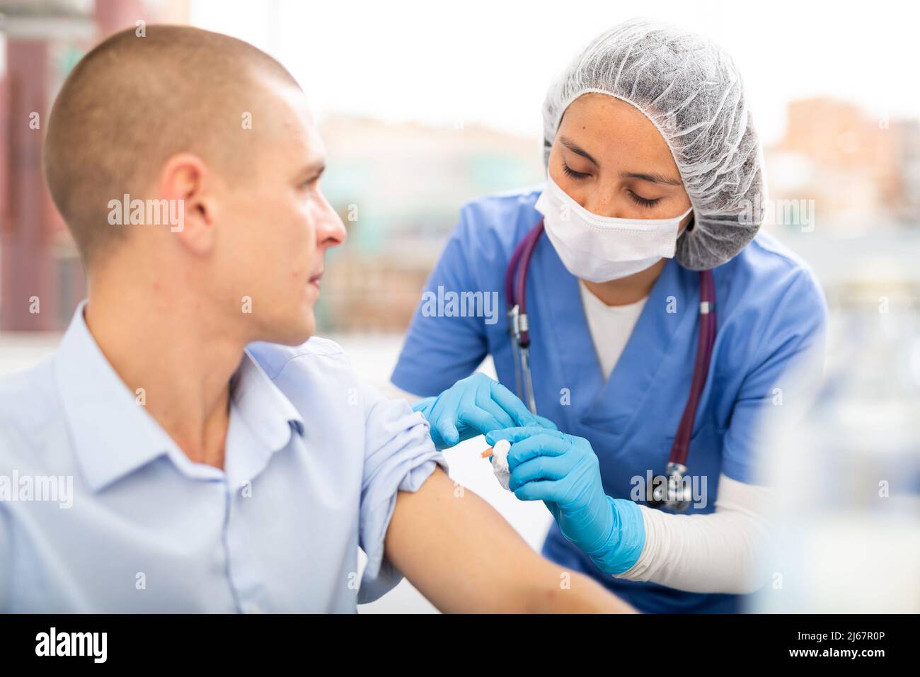 Nurse giving male patient injection hi-res stock photography and images ...