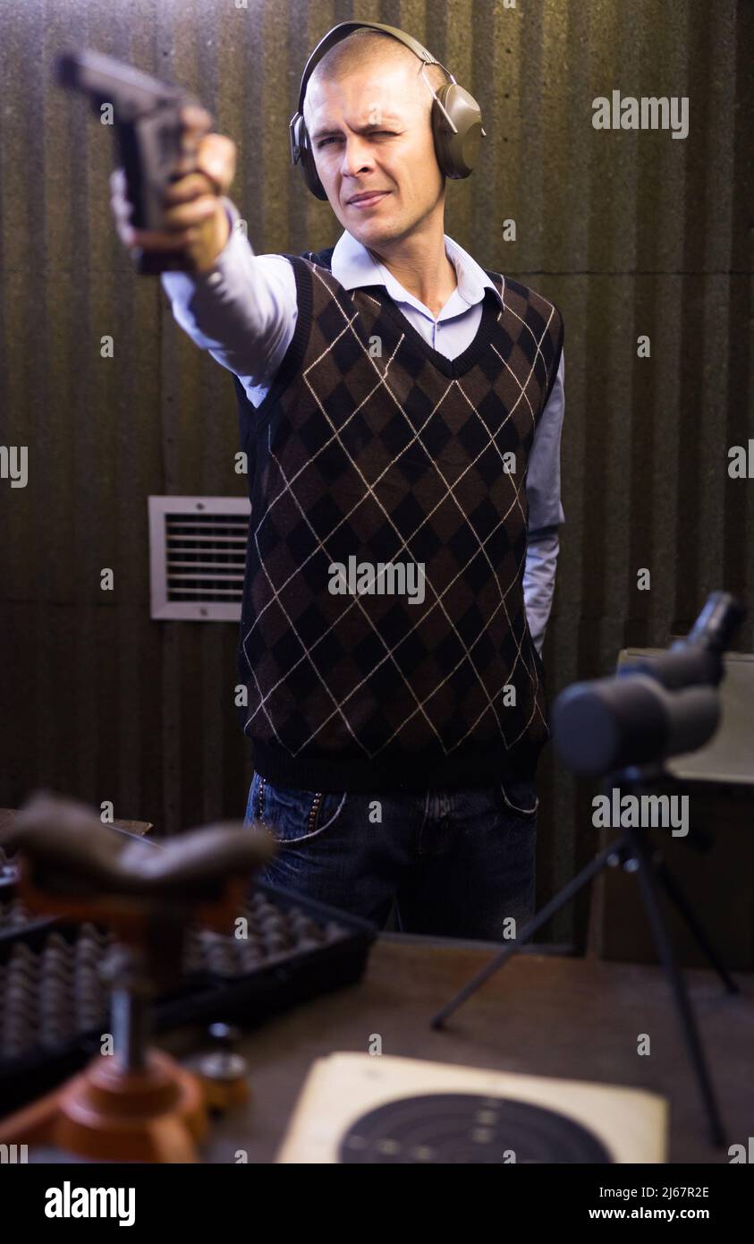 Shooting a combat pistol in shooting range Stock Photo - Alamy